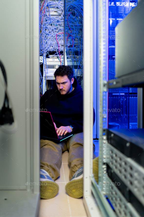 focused hacker in data center hacking software system vulnerable cyber ...