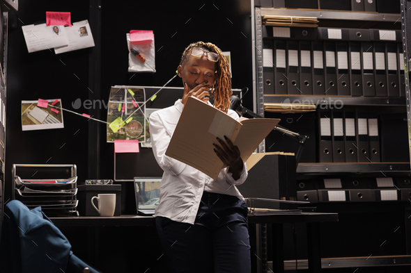 Law enforcement agency detective reading criminal investigation ...