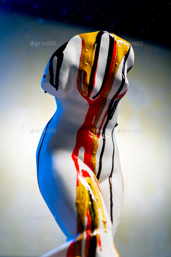 a white sculpture in the form of a body standing a barrel a museum ...