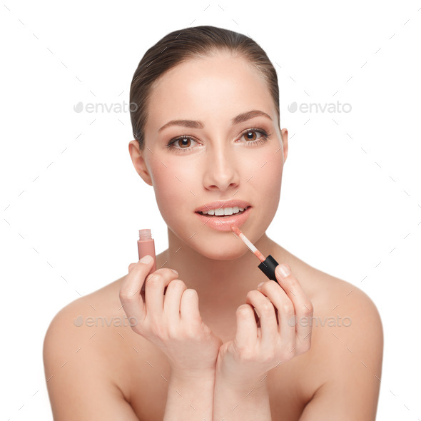 Giving her lips that extra touch Stock Photo by YuriArcursPeopleimages
