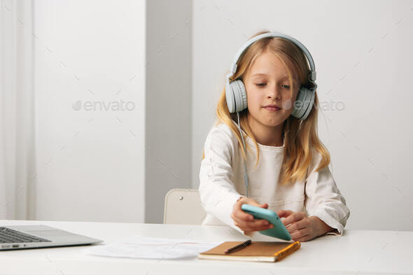 Smiling girl doing elearning at home with laptop modern education in a ...
