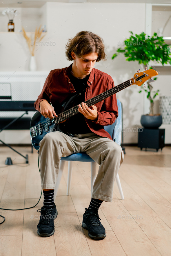 rock artist with electric guitar during rehearsal playing track musical ...