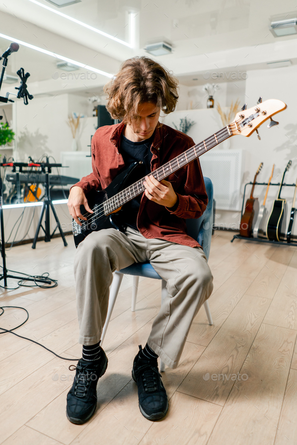 rock artist with electric guitar during rehearsal playing track musical ...