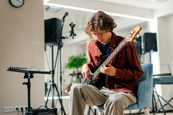 rock artist with electric guitar during rehearsal playing track musical ...