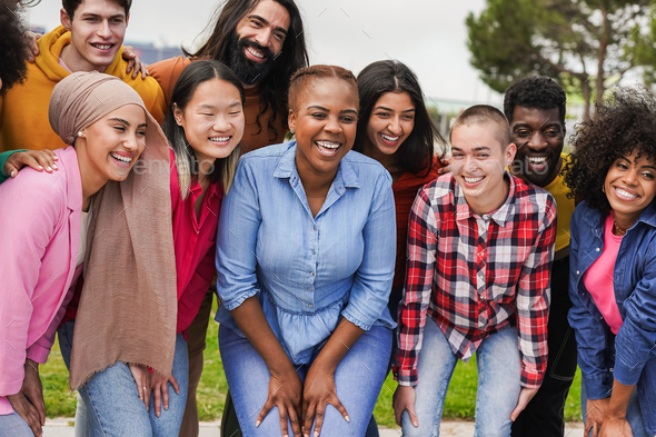 Crowd of happy multiracial people having fun in the city while taking a ...