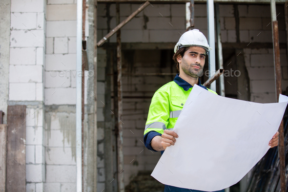 man engineer builder house construction holding blueprint drawing ...