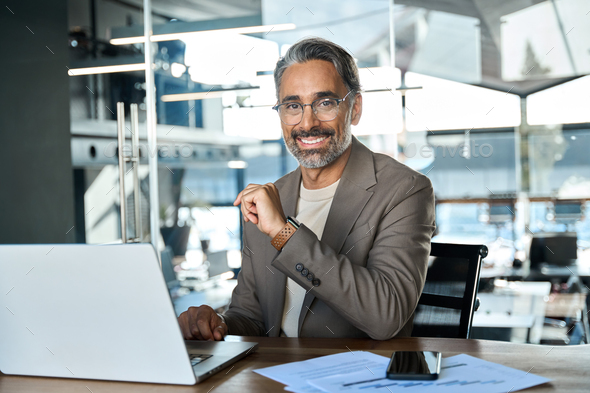 Happy middle aged business man ceo working on laptop in office, portrait. Stock Photo by insta ...