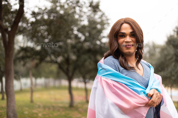Trans woman showing trans flag with proud expression. LGTB concept ...