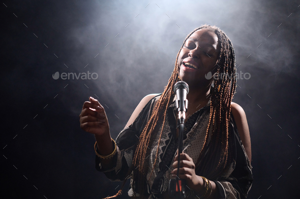 Talented Black Woman Singing on Stage with Smoky Background Stock Photo ...
