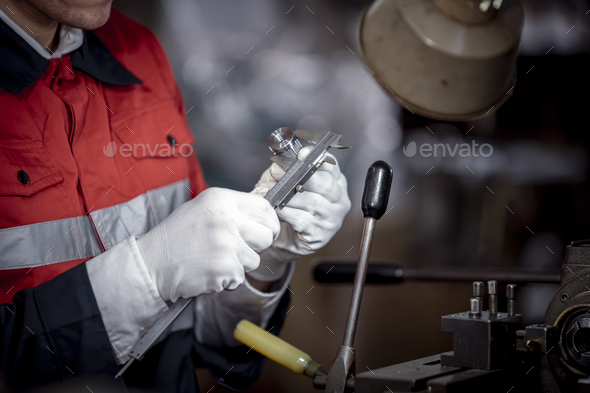 Industry engineer wearing safety uniform used vernier caliper to ...