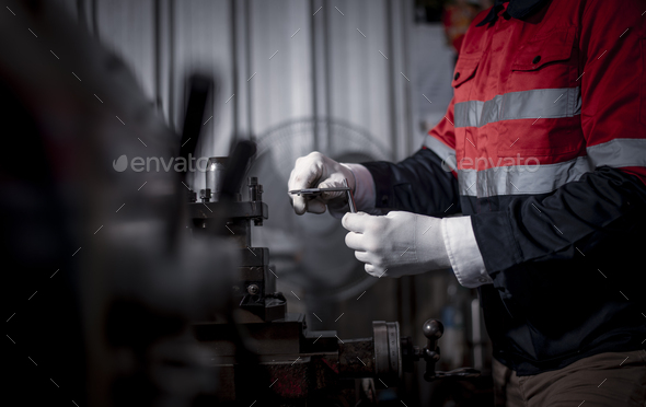 Industry engineer wearing safety uniform used vernier caliper to ...