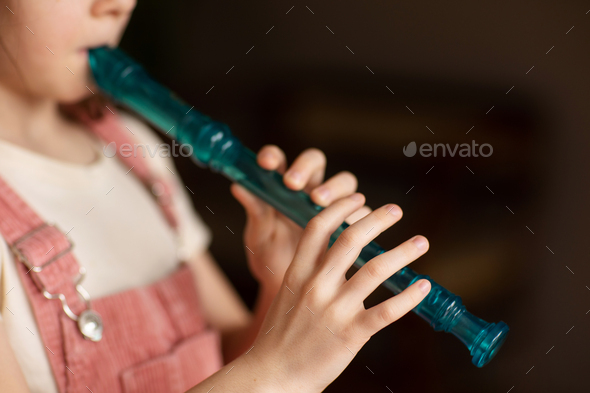 child playing flute. learning to play musical instruments at music ...
