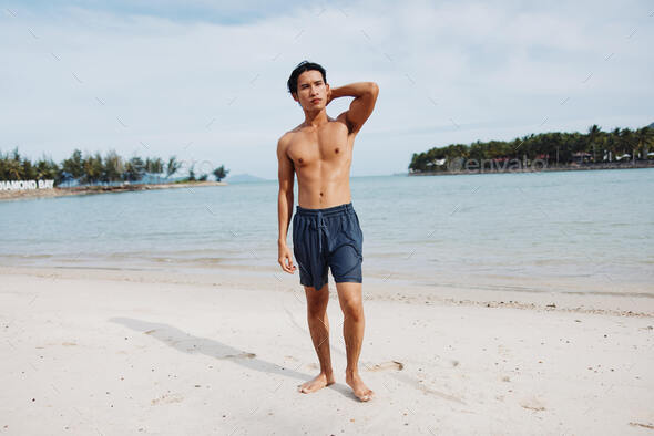 Smiling Asian Man Enjoying Beach Vacation: Muscular Torso and Happy ...