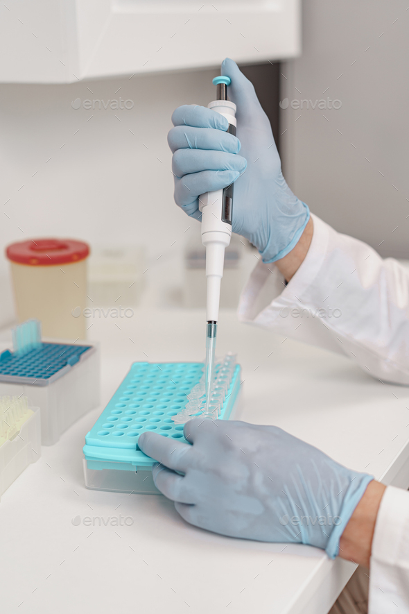 Close up of scientist is using micropipette for biochemical test ...