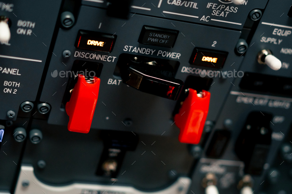 cockpit of a passenger plane with many buttons on the control panel of ...