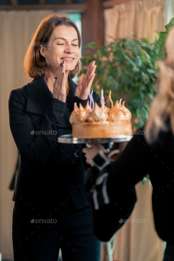 birthday girl clapping hands after blowing out candles on birthday cake ...
