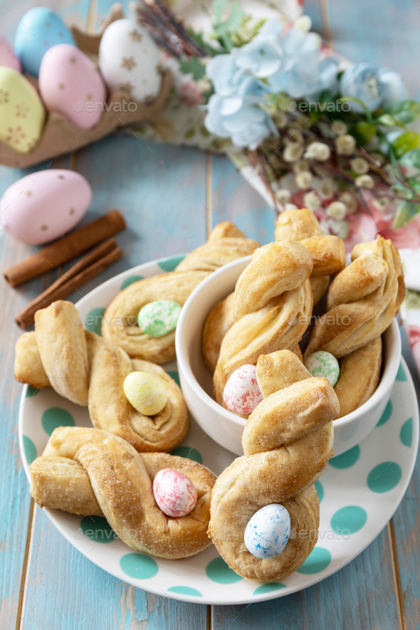 Easter rabbit-shaped buns puff pastry with cinnamon on a wooden blue ...