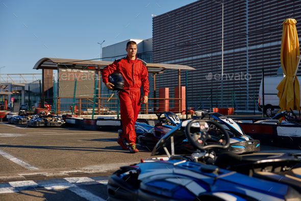 Go-kart driver walking to car before race at starting line Stock Photo ...