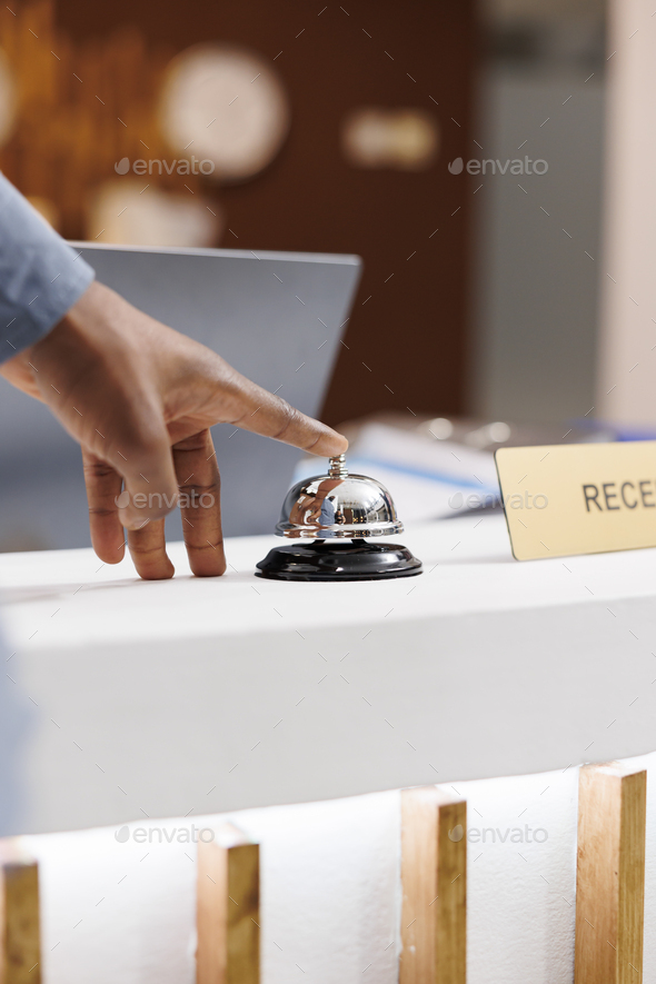 Male hand pressing hotel front desk bell Stock Photo by DC_Studio ...
