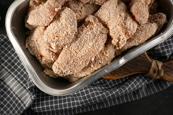 Raw pieces chicken breast breaded ready for frying. Stock Photo by foto ...