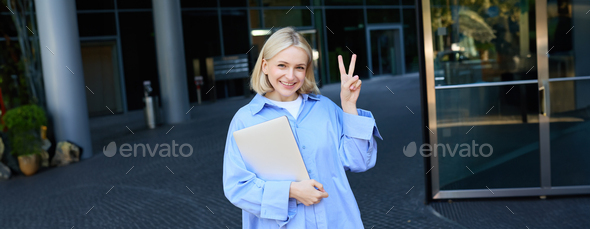 Young positive female model, student with notebooks and study material ...