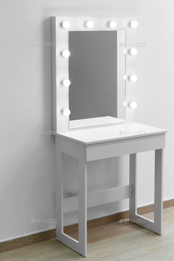 Modern white makeup dressing table with mirror and backlight on a white ...