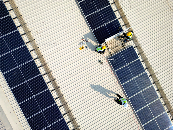 Solar panels installation. Construction workers with safety hardhat ...
