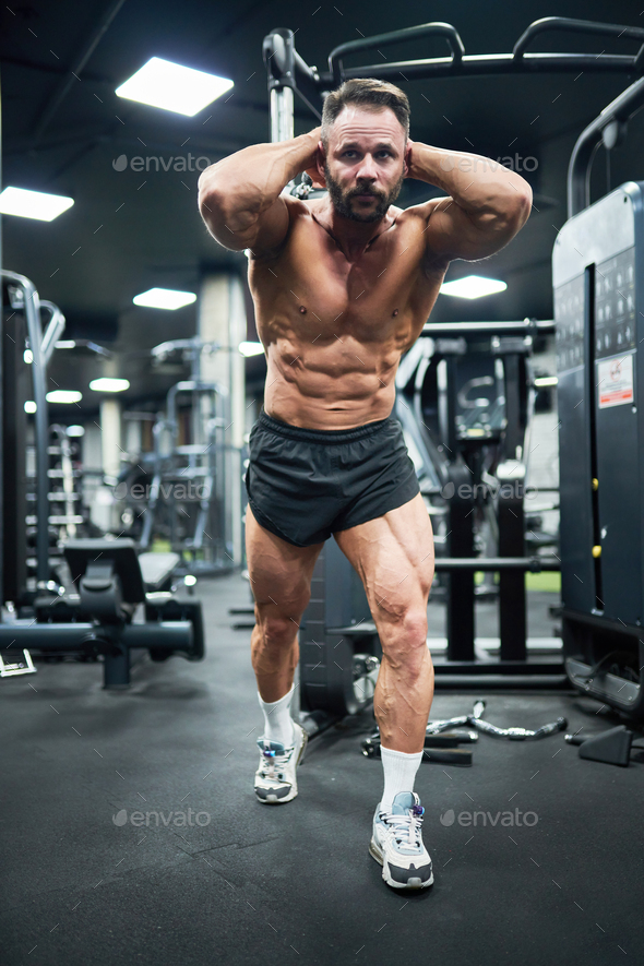 Focused bodybuilder pulling weight, having workout in gym. Stock Photo ...