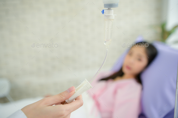 Female doctor with IV equipment will give IV fluids and examine ...