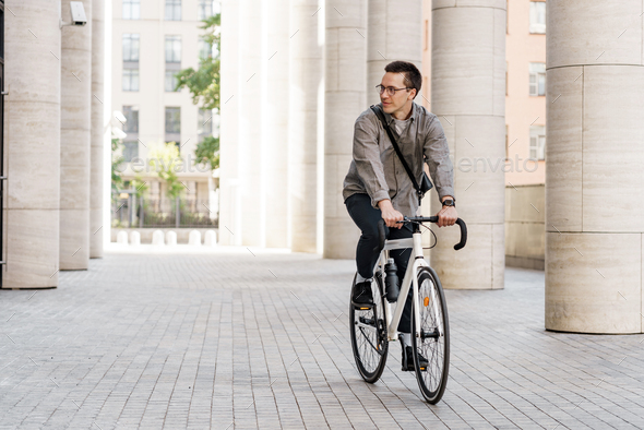 Modern urban commuter on a stylish bicycle in a cityscape, embodying ...