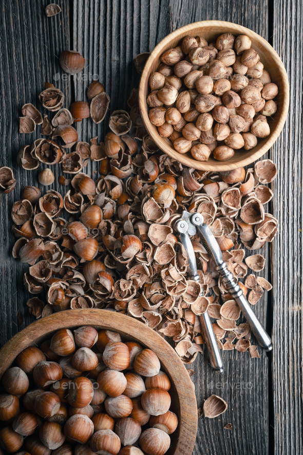 Whole hazelnuts nuts, heap of shells and kernels Stock Photo by ivankmit