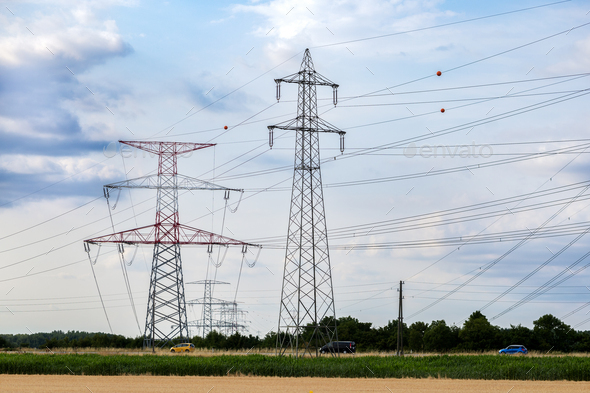 high-voltage power line with signal red marker balls on wires for small ...