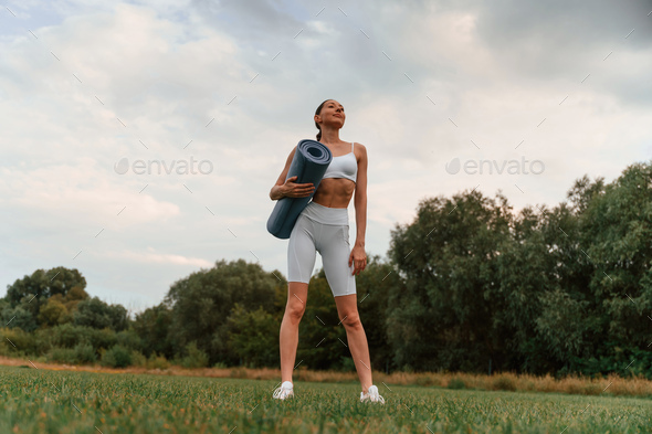 Young caucasian woman with slim body shape is in the fitness clothes ...