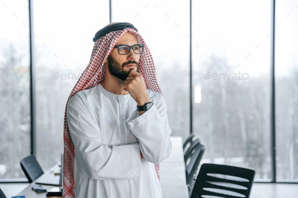 Young investor is standing. Successful Muslim businessman in ...