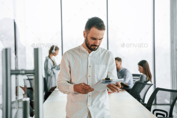 Some paperwork. Team of office employees are together indoors Stock ...