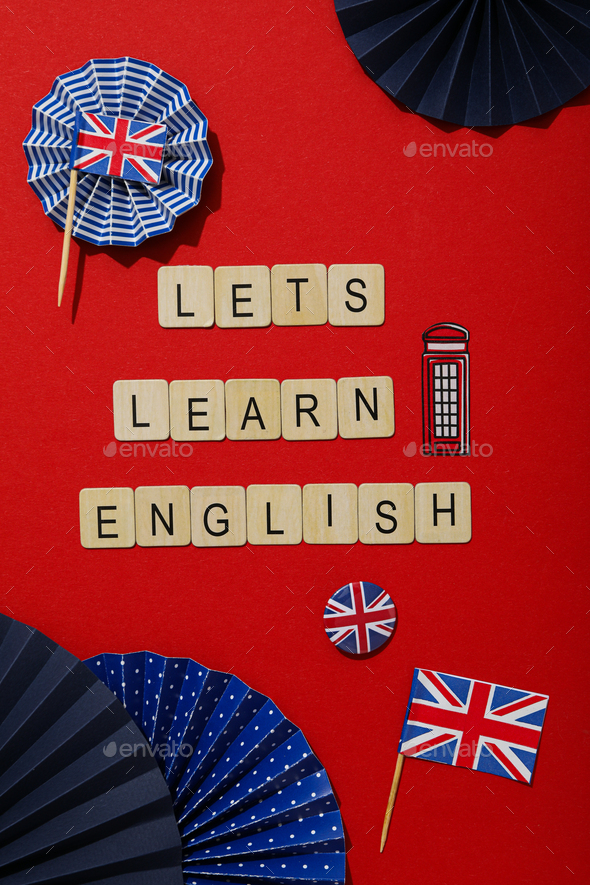 The phrase "let's learn English" on a red background. Stock Photo by ...