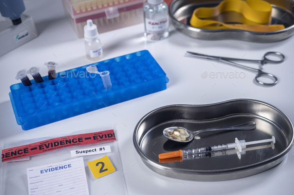 Syringe and spoon in police drug investigation department, concept ...