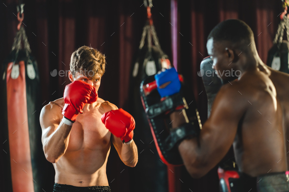 Active athletes fit men kick boxing doing sport training workout in gym ...