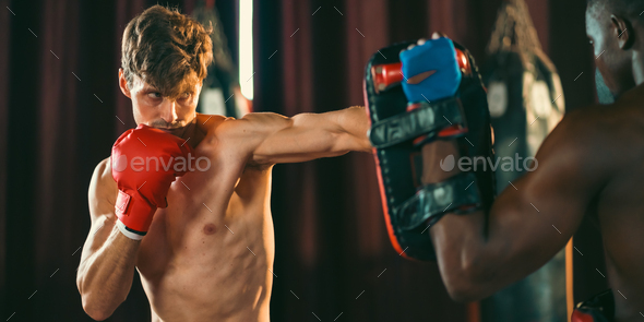 Active athletes fit men kick boxing doing sport training workout in gym ...