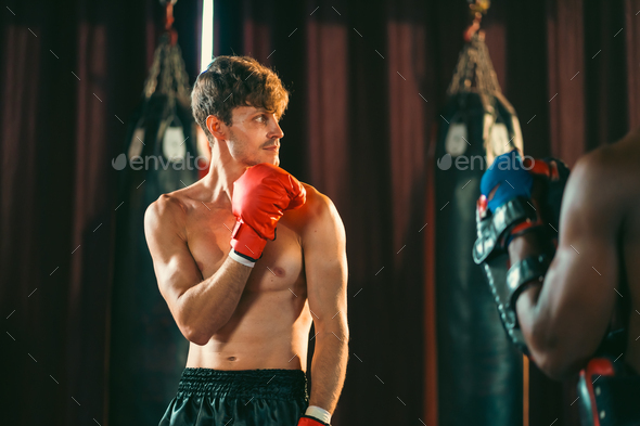 Active athletes fit men kick boxing doing sport training workout in gym ...