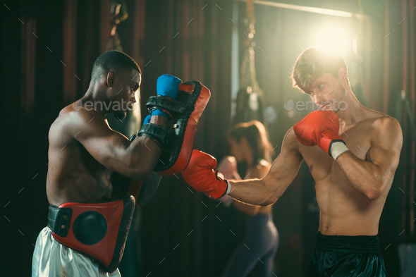 Active athletes fit men kick boxing doing sport training workout in gym ...