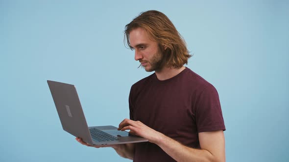 Guy Holding Laptop Using It Smiling and Acting Like Inviting you to ...