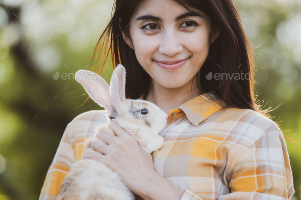 relationships of cheerful rabbit and happy young human girl, woman ...