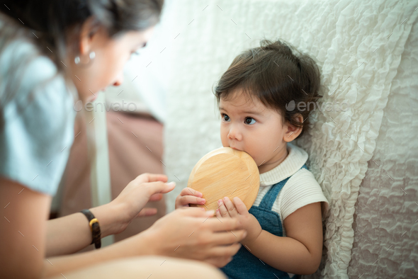 baby first steps. baby goes her mother at window learns to walk to take ...
