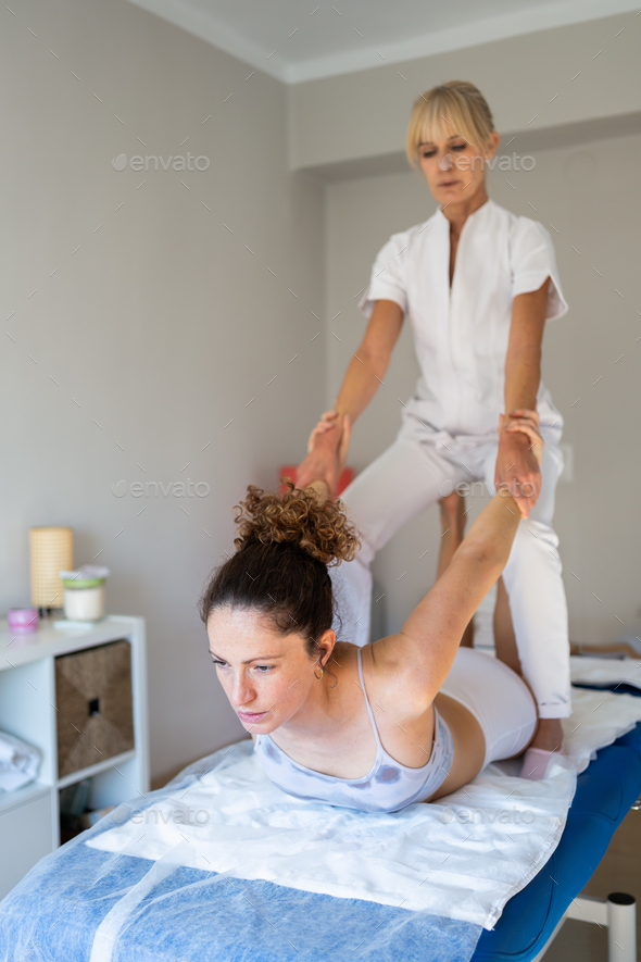 Female osteopath treating back and shoulders of patient Stock Photo by ...