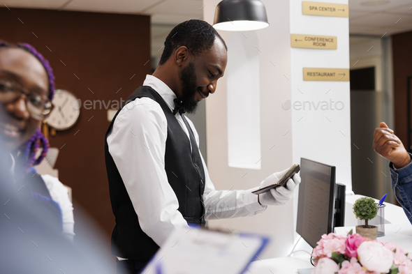 Hotel front desk staff register guests Stock Photo by DC_Studio | PhotoDune