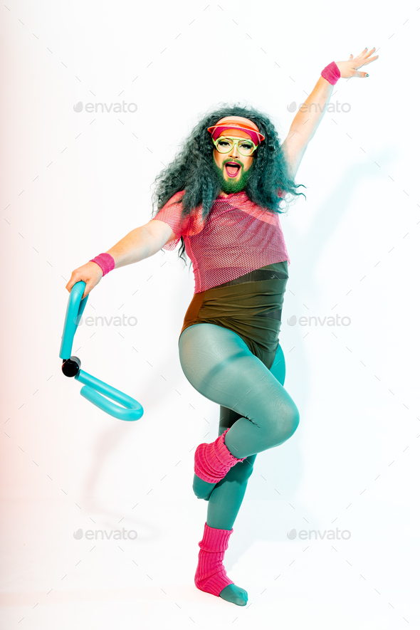 Excited man in drag queen costumes dancing in studio with thigh master ...