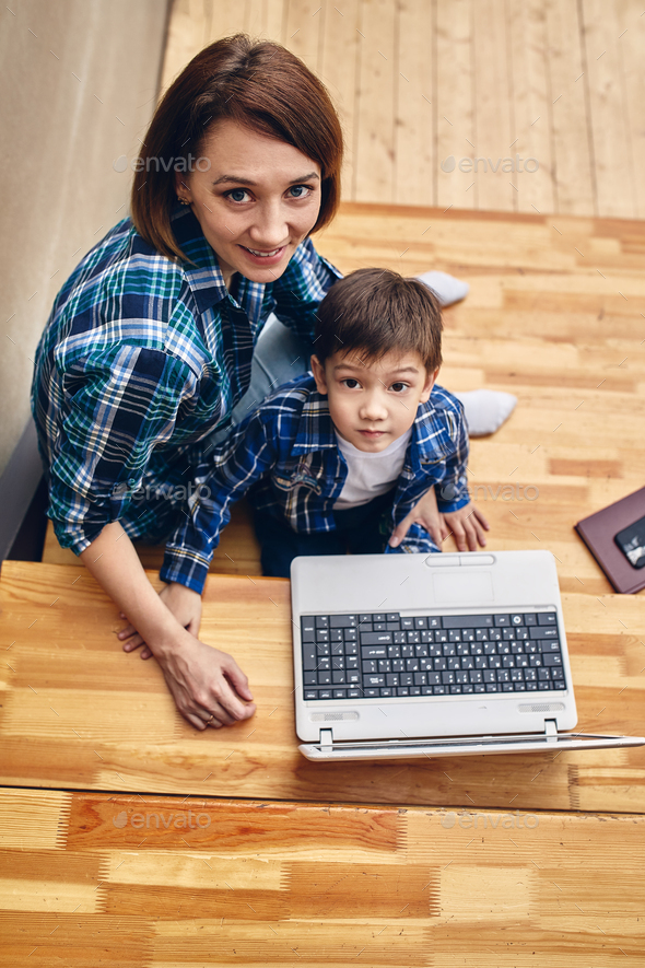 Mom and son are doing homework on the computer. Concept mom and ...