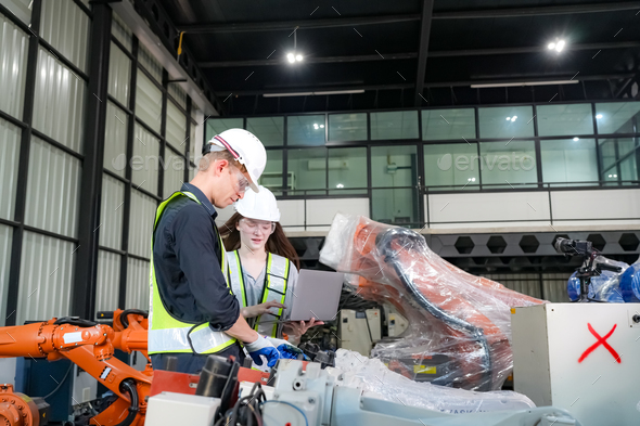 Engineer testing a robotic production simulator in robotics research ...