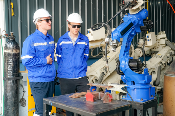 Engineer testing a robotic production simulator in robotics research ...